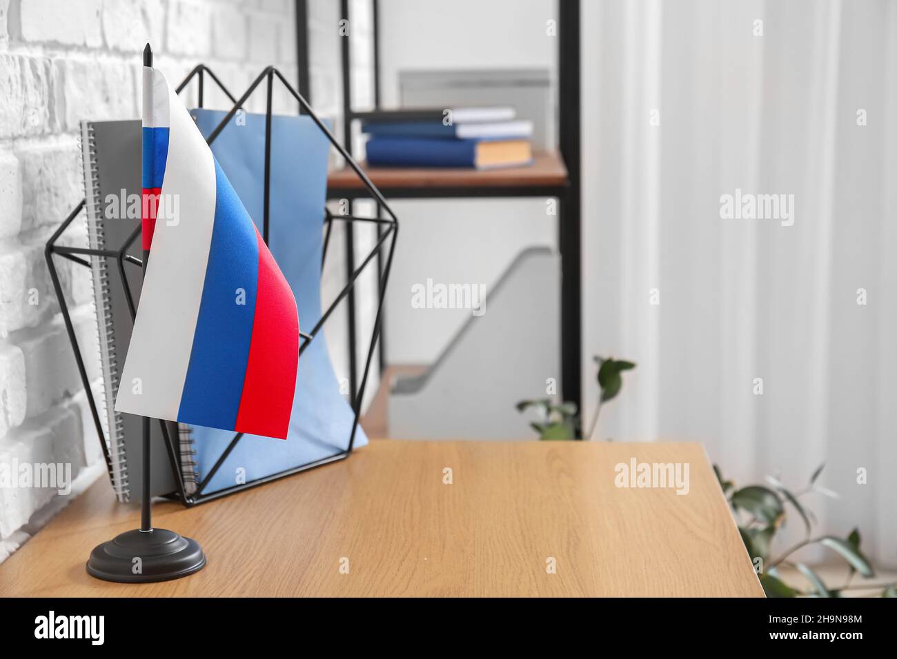 Modern workplace with Russian flag in room Stock Photo - Alamy