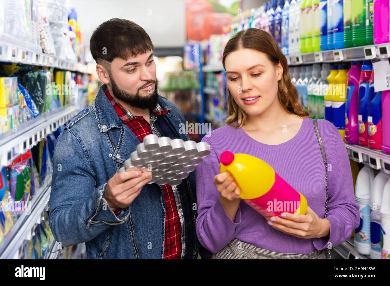 Couple shopping detergent products Stock Photo - Alamy