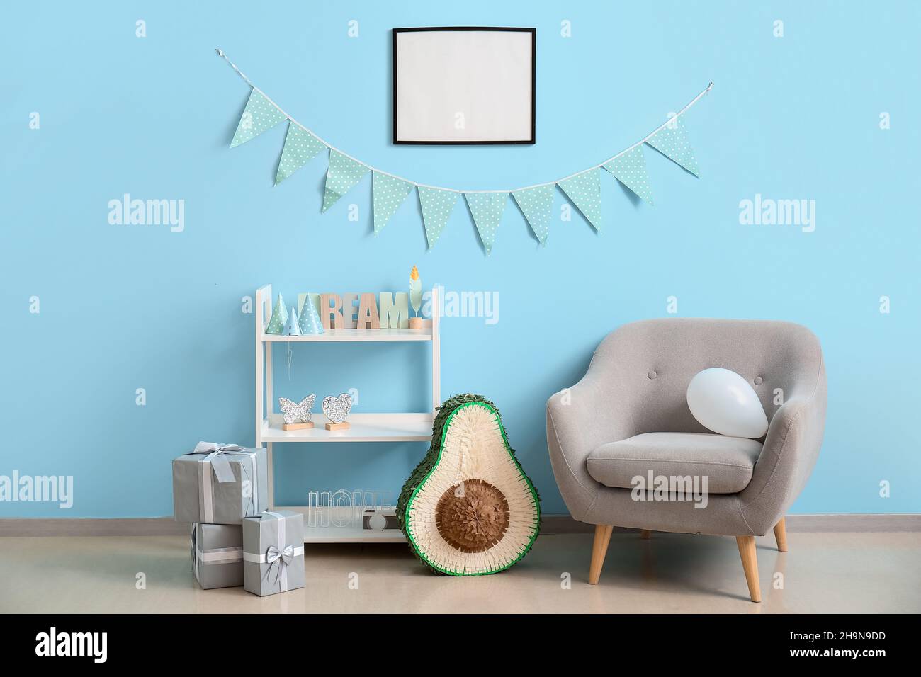 Interior of stylish room with armchair, shelving unit and Mexican ...