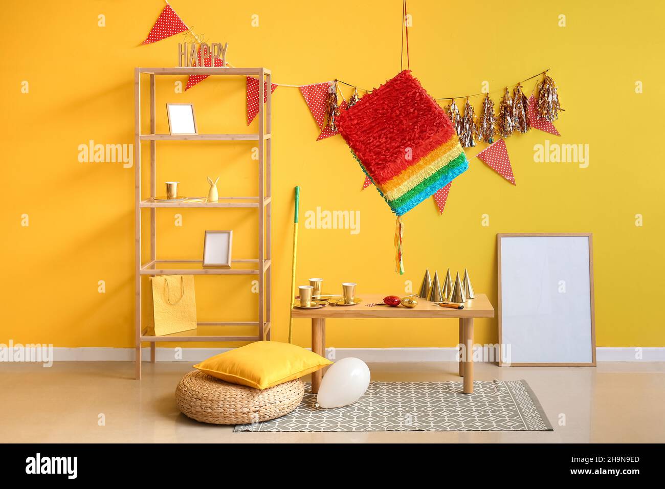Interior of stylish room with hanging Mexican pinata decorated for ...