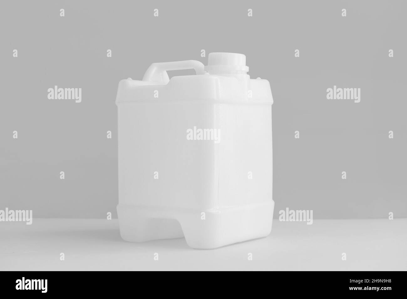 Plastic jerrycan on grey background Stock Photo - Alamy