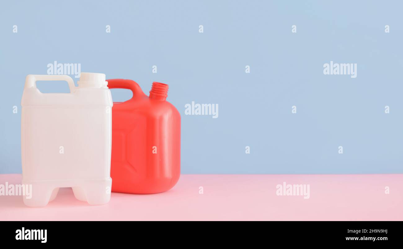 Plastic jerrycans on color background Stock Photo - Alamy