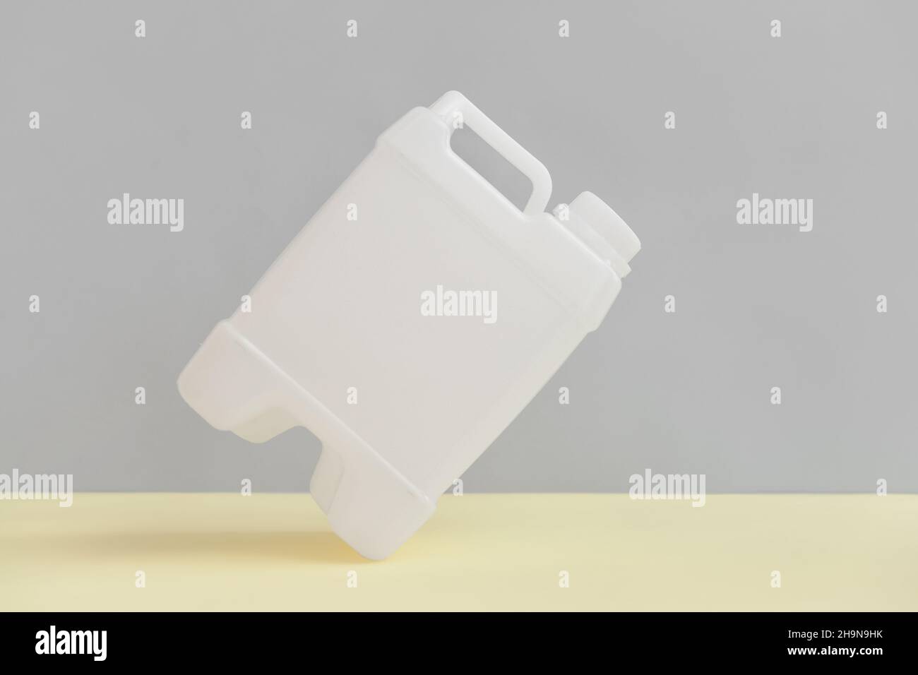 Plastic jerrycan on grey background Stock Photo - Alamy