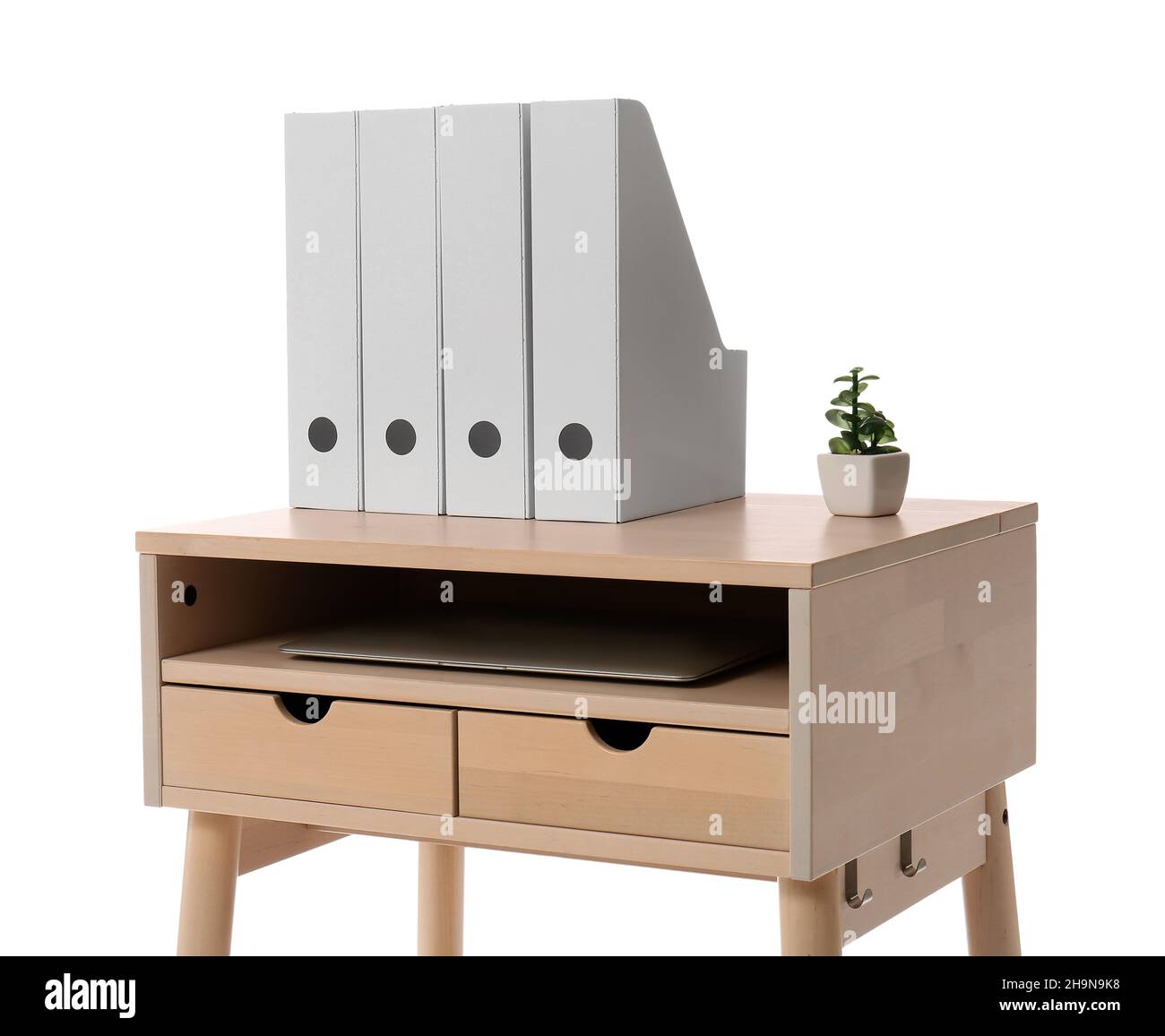 Stand-up desk with folders and houseplant on white background Stock ...