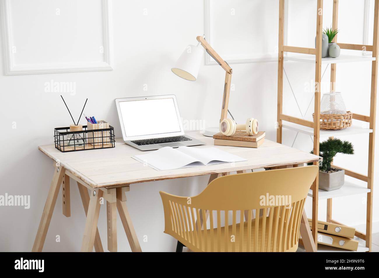 Modern workplace with laptop in room Stock Photo - Alamy