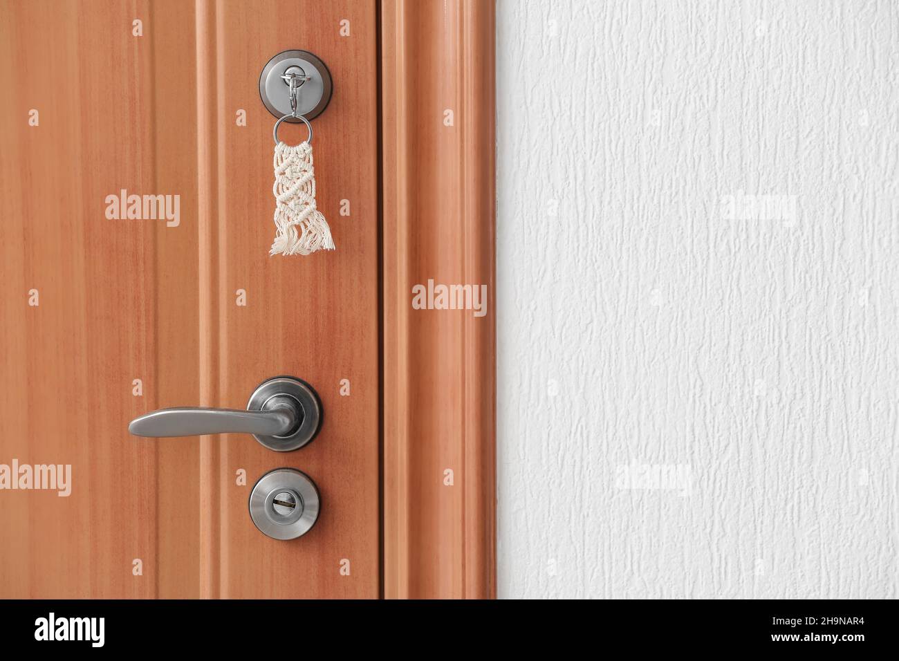 Key inserted in door hole Stock Photo - Alamy