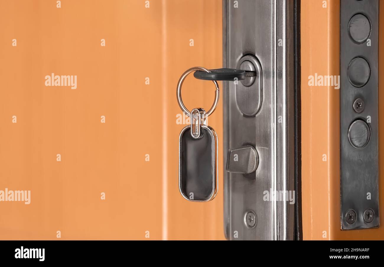 Key inserted in door hole, closeup Stock Photo - Alamy