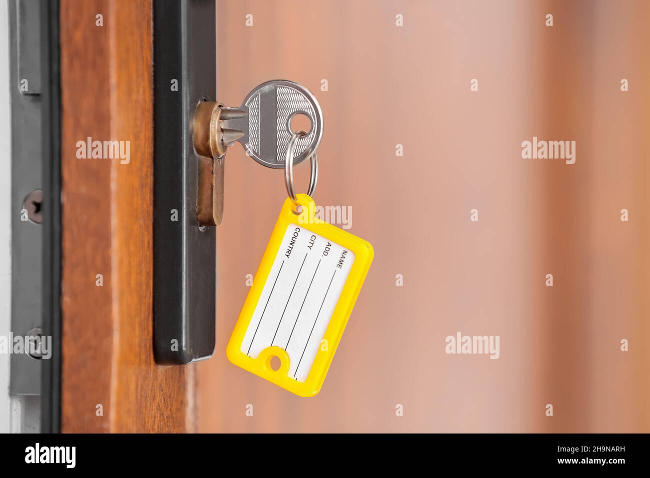 Key inserted in door hole, closeup Stock Photo - Alamy