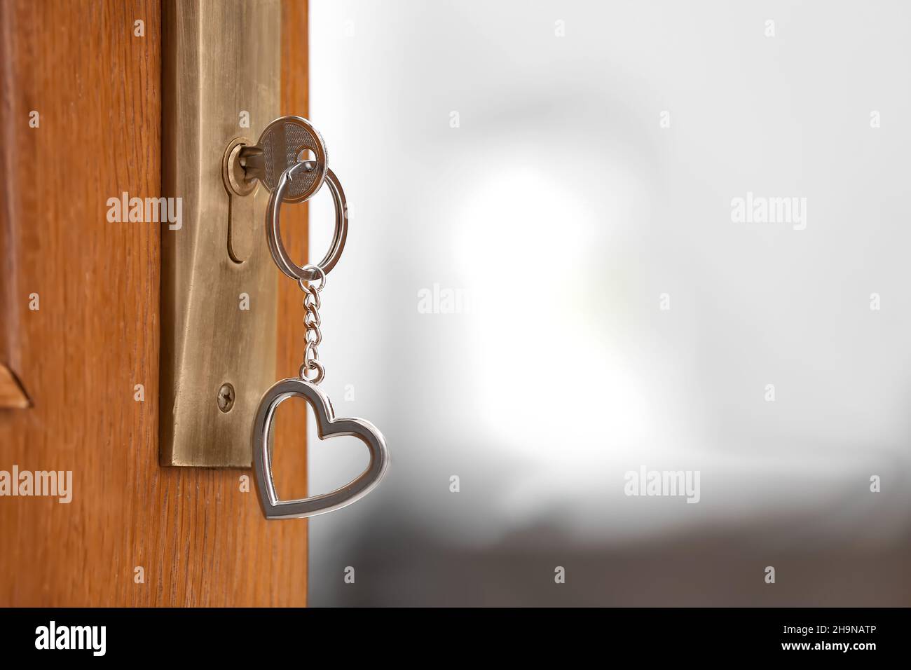 Key inserted in door hole, closeup Stock Photo - Alamy