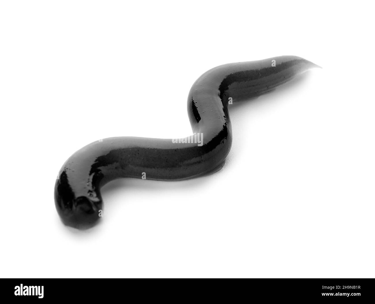 Sample of black toothpaste on white background Stock Photo - Alamy