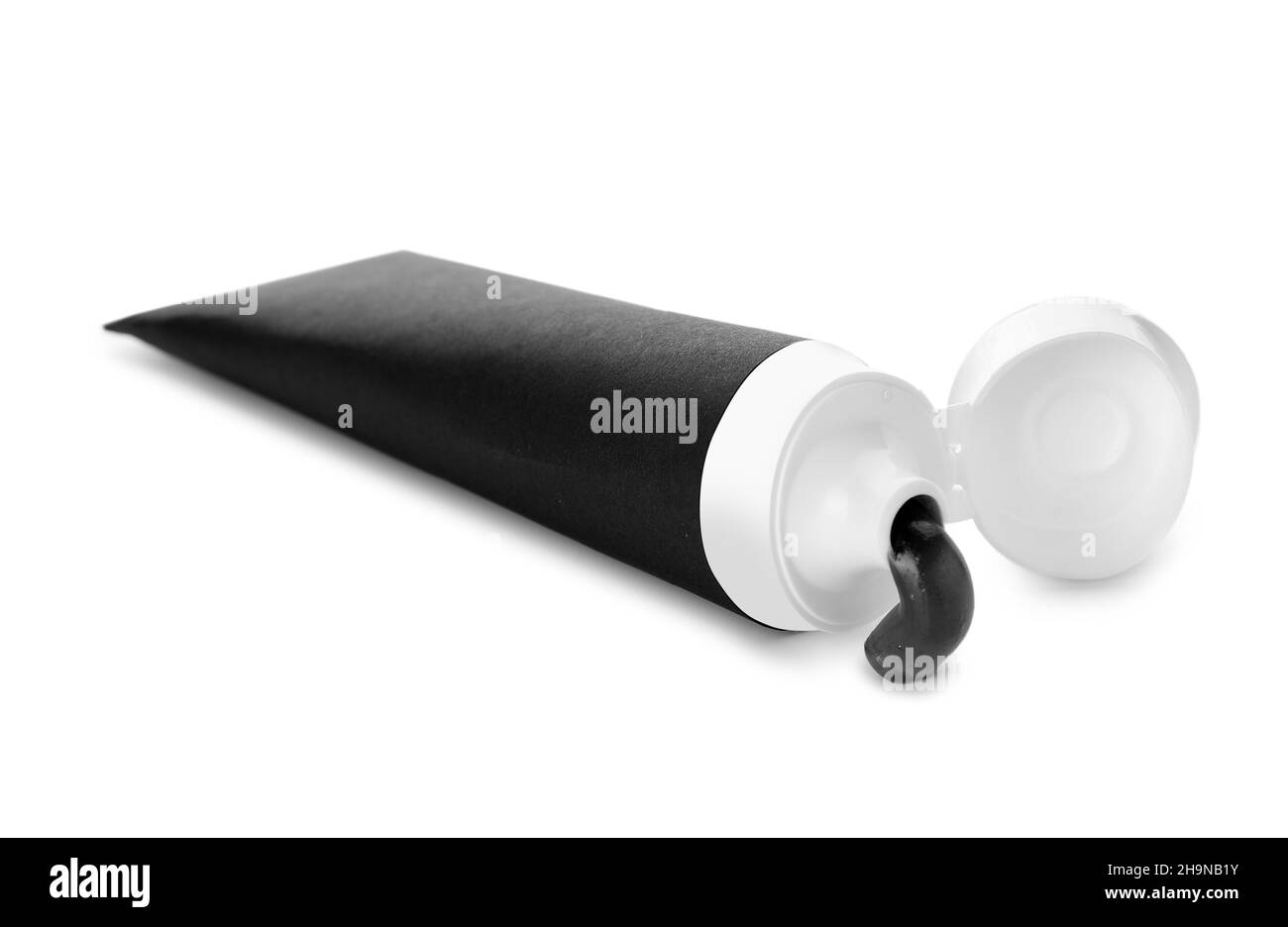 Tube with black toothpaste on white background Stock Photo - Alamy