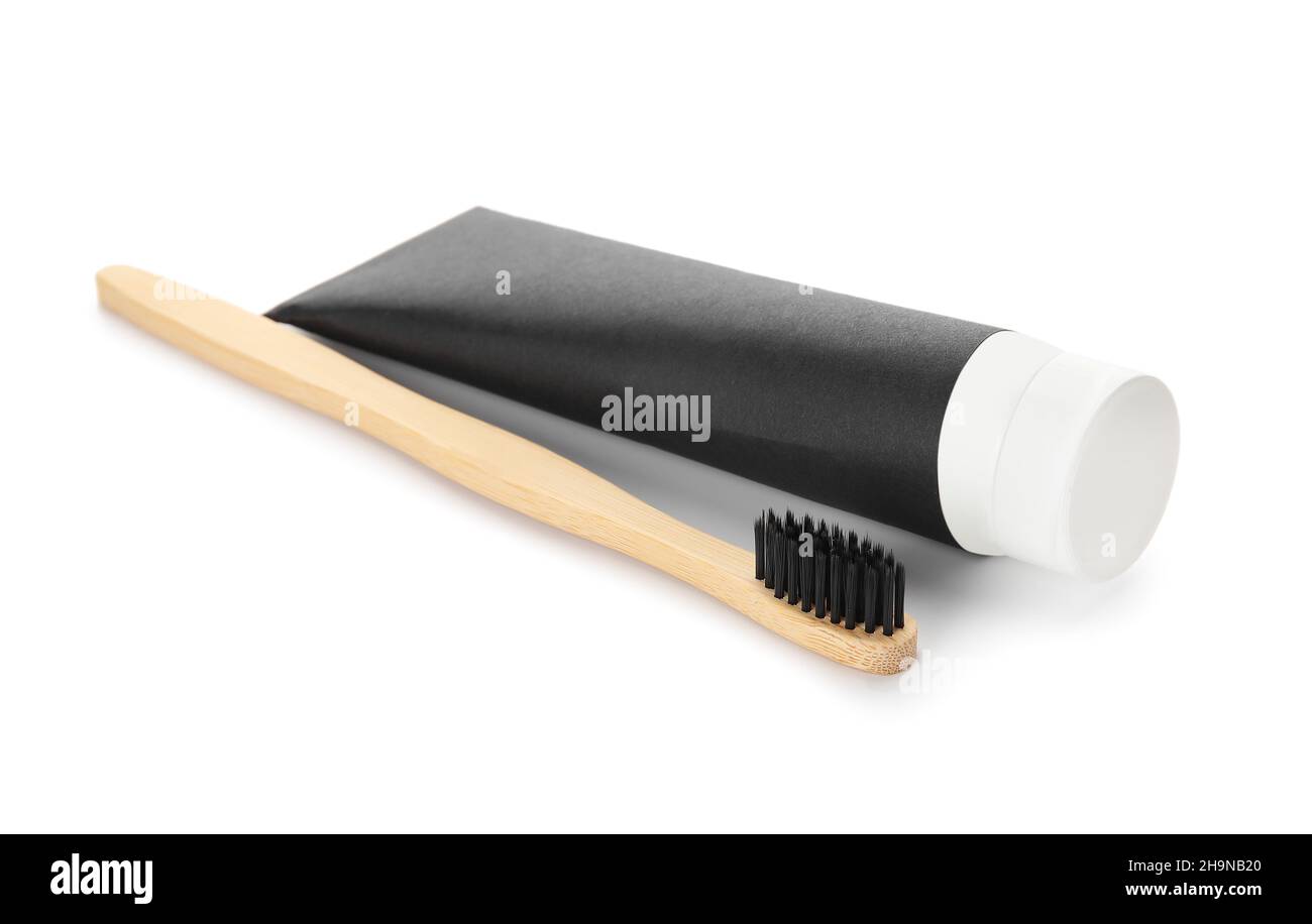 Tube with black tooth paste and brush on white background Stock Photo ...