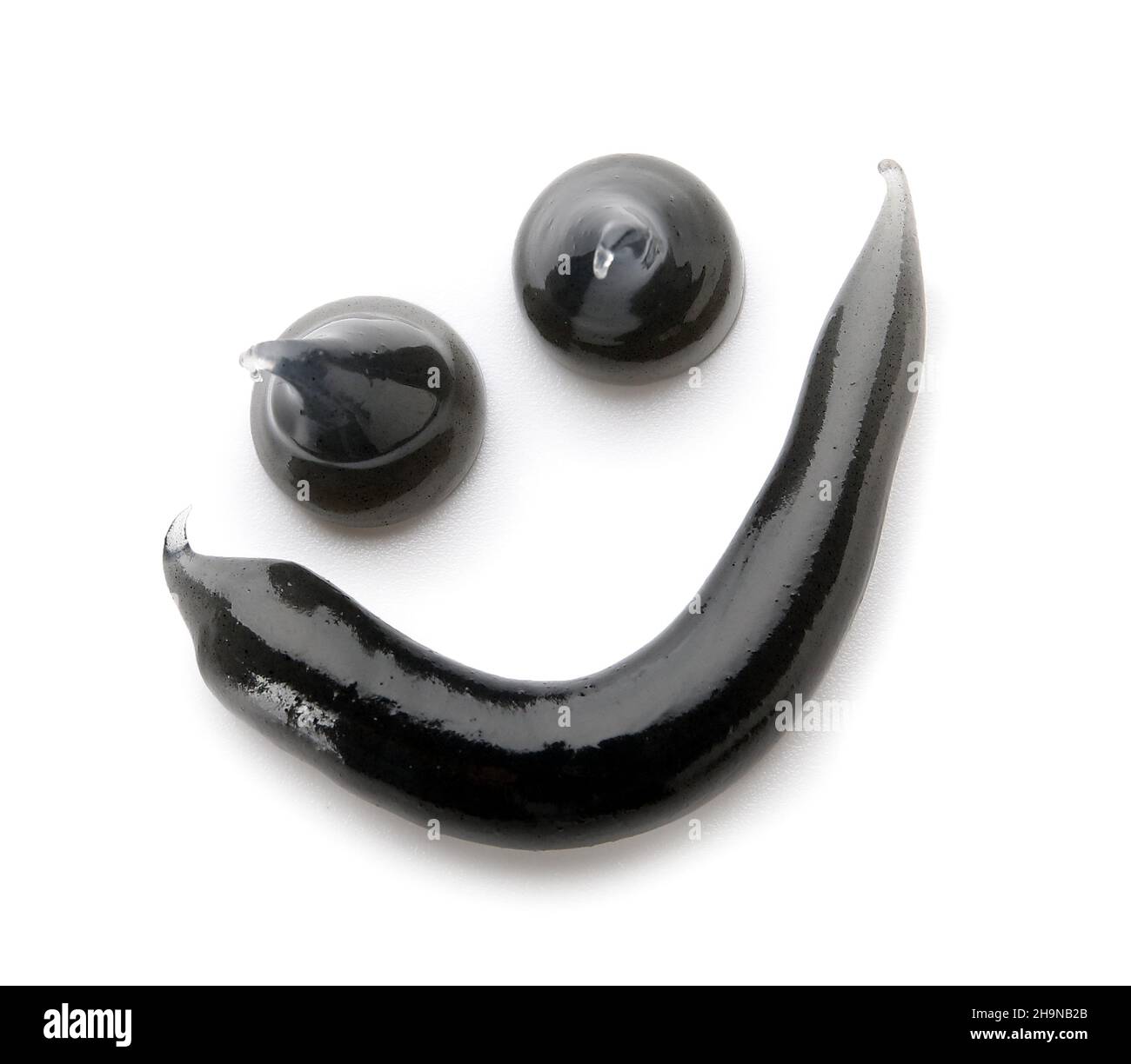 Smile made of black toothpaste on white background Stock Photo - Alamy