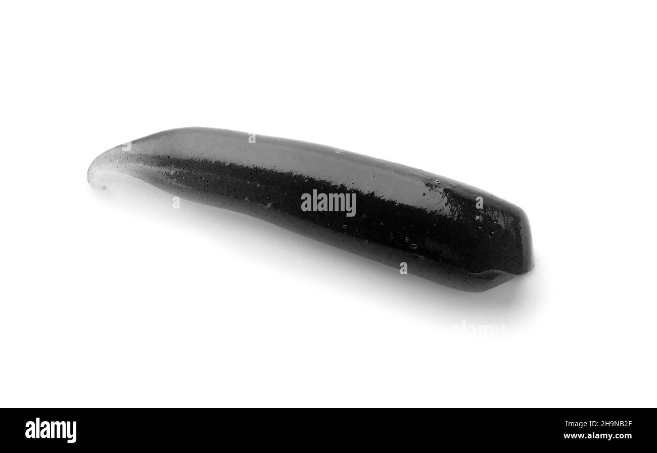 Sample of black toothpaste on white background Stock Photo - Alamy