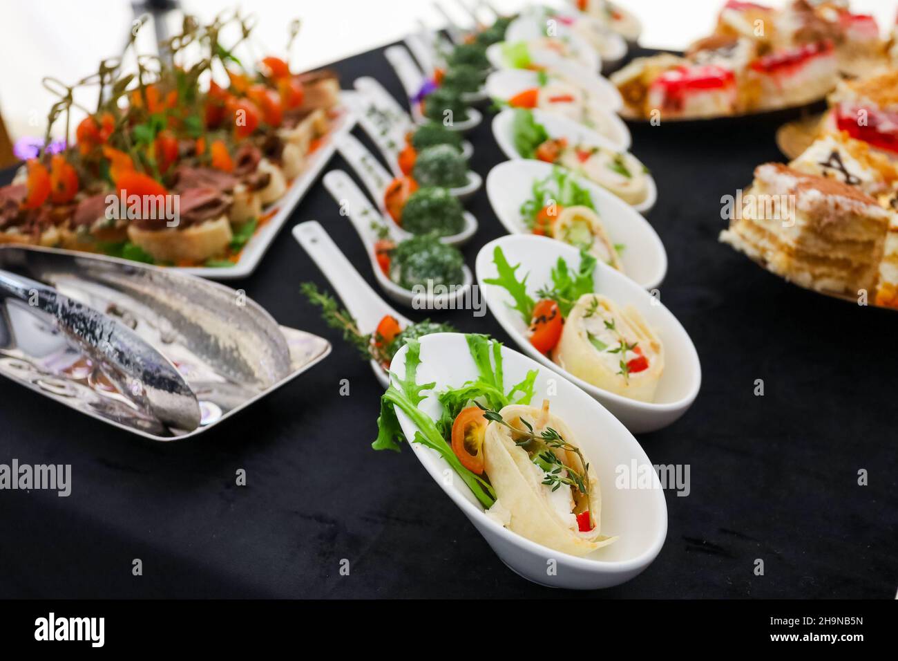 Portion snacks on a buffet table in ceramic dishes Stock Photo - Alamy