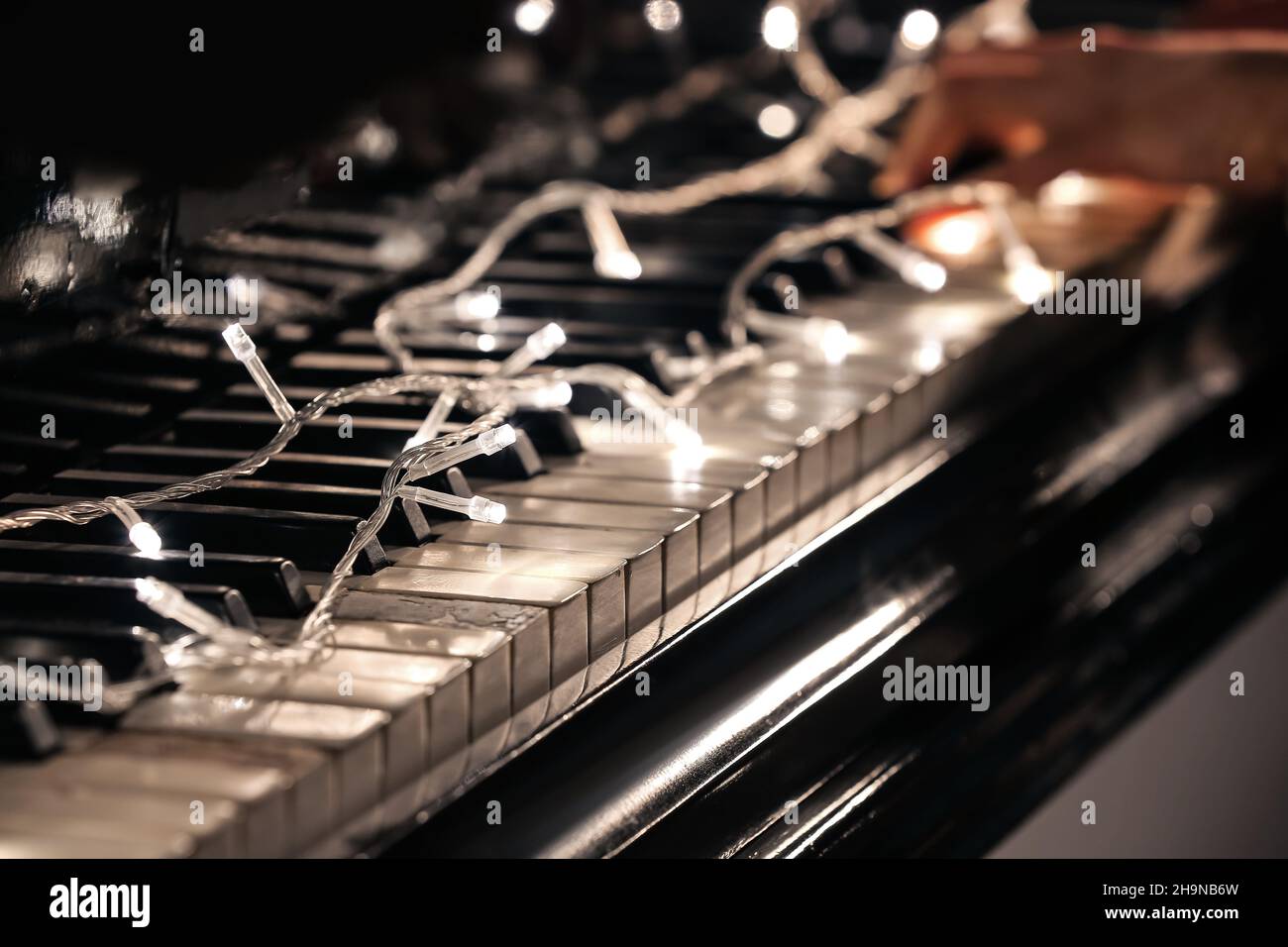 Christmas glowing lights on piano, closeup Stock Photo - Alamy