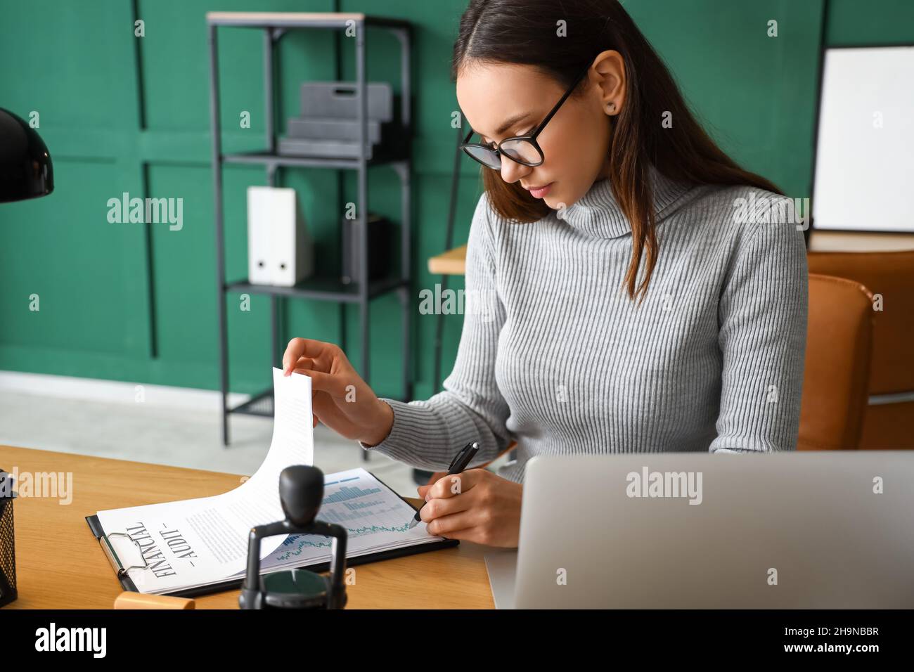 Female notary public working in office Stock Photo - Alamy