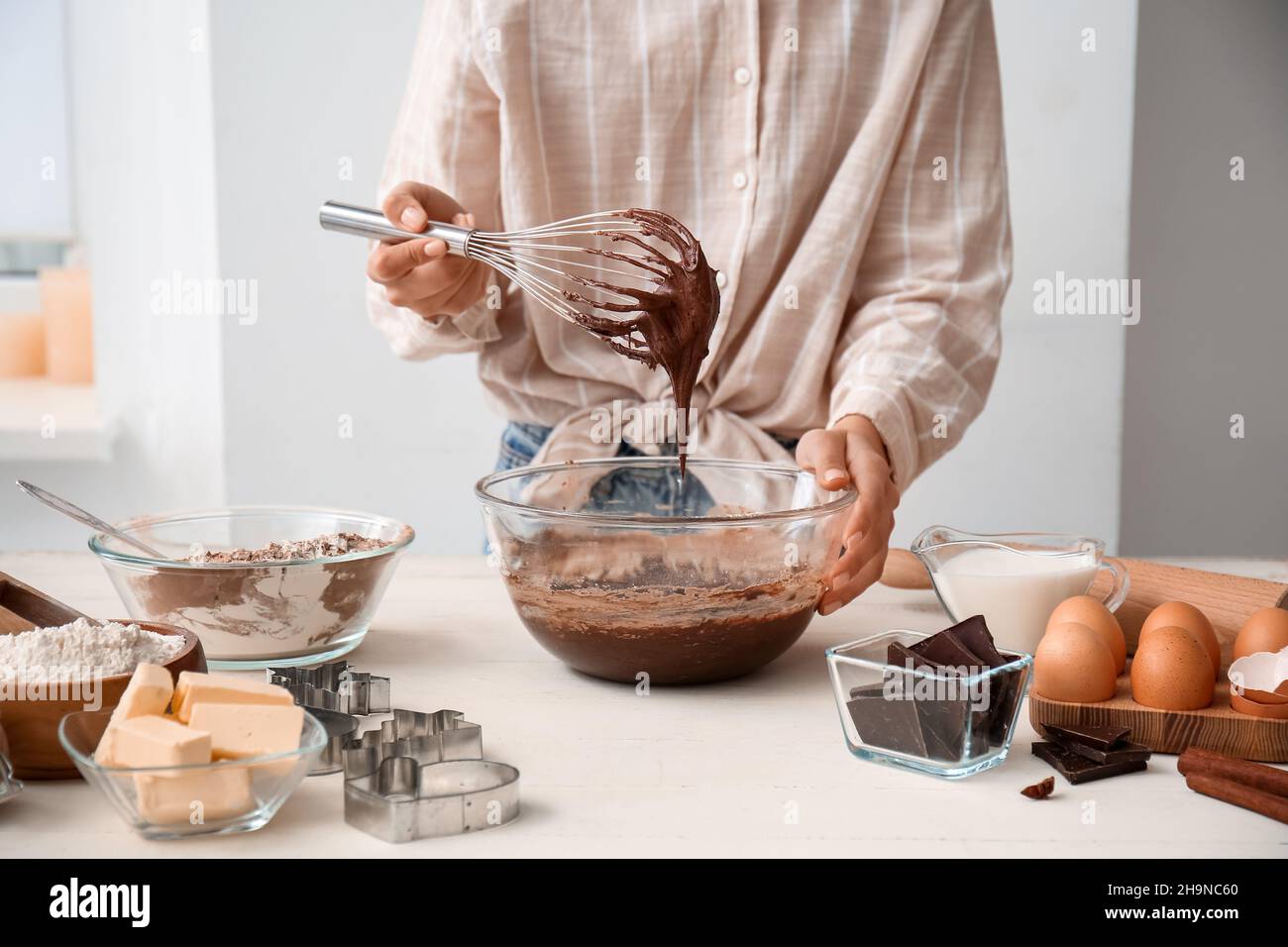 Woman preparing chocolate dough at kitchen table, closeup Stock Photo ...
