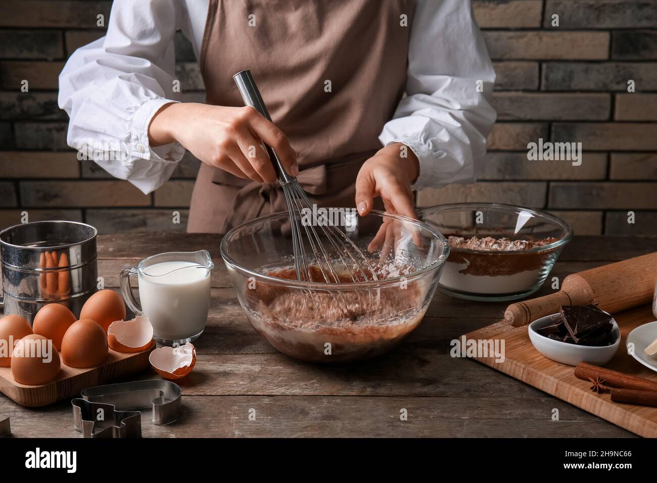 Woman preparing chocolate dough at kitchen table, closeup Stock Photo ...