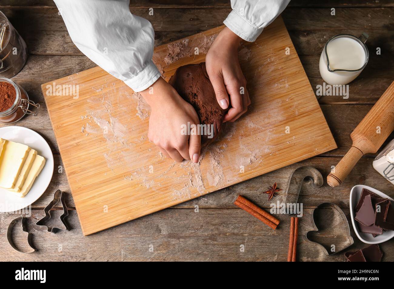 Woman preparing chocolate dough on wooden background Stock Photo - Alamy