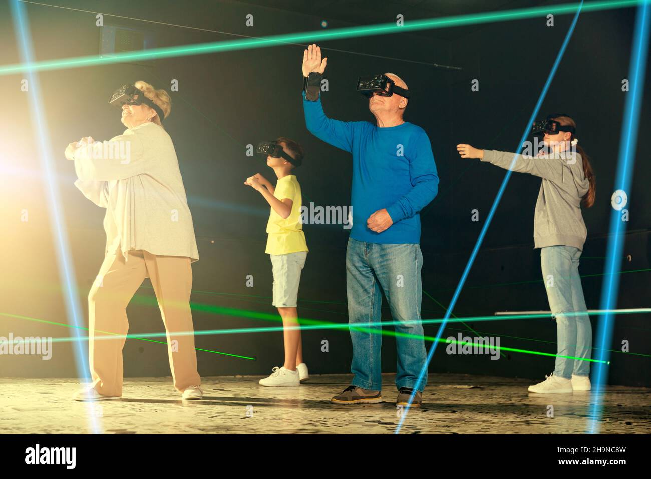 Family are wearing virtual reality goggles in quest room Stock Photo ...