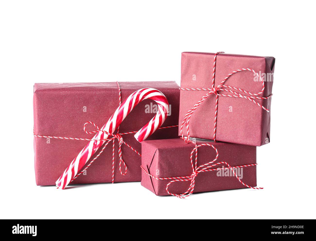 Beautiful Christmas gift boxes and candy cane isolated on white ...