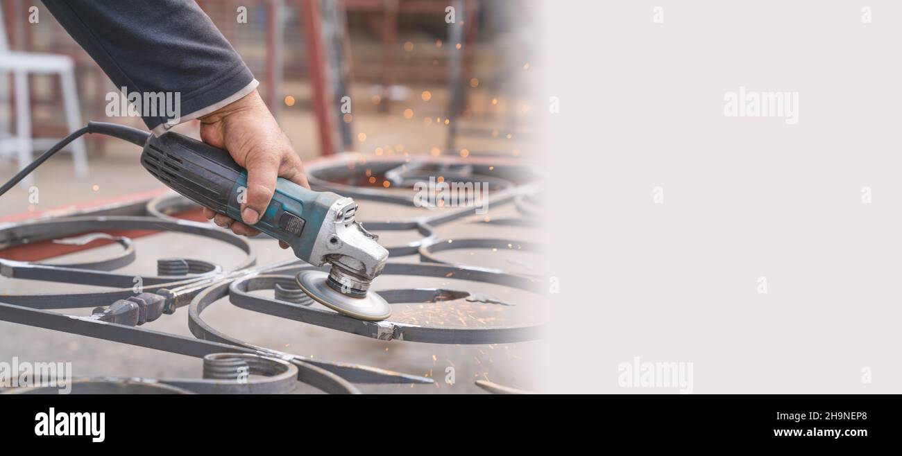 Metal grinding with angle grinder. Male hand and instrument close-up ...