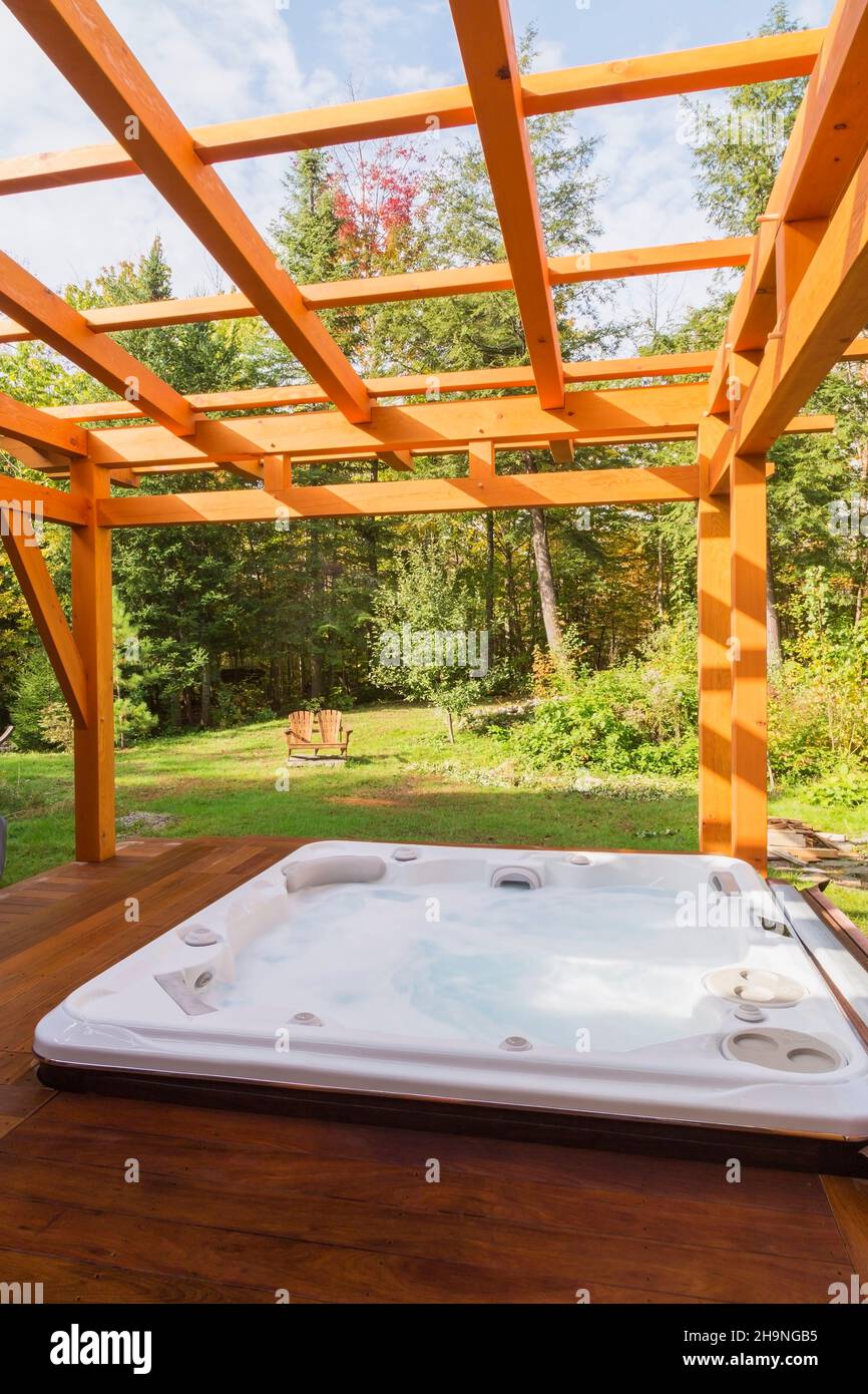 Oiled Eastern white pine timber frame pergola and spa on raised wood ...