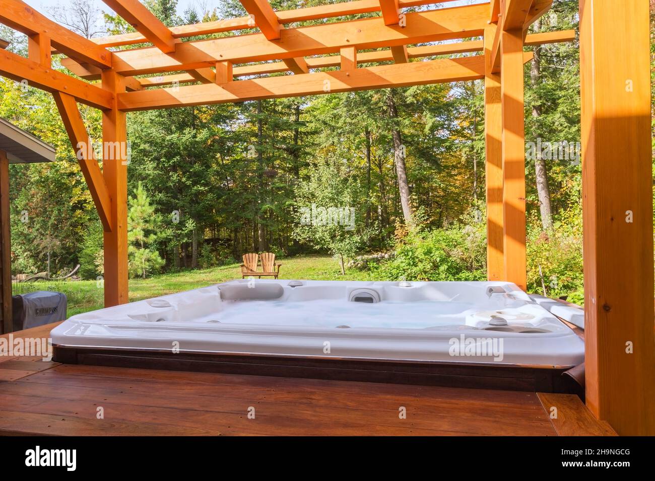 Oiled Eastern white pine timber frame pergola and spa on raised wood ...