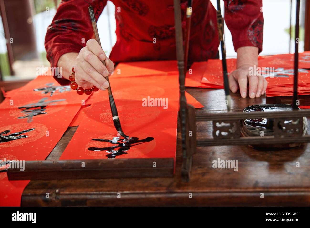 Older men write calligraphy Stock Photo - Alamy