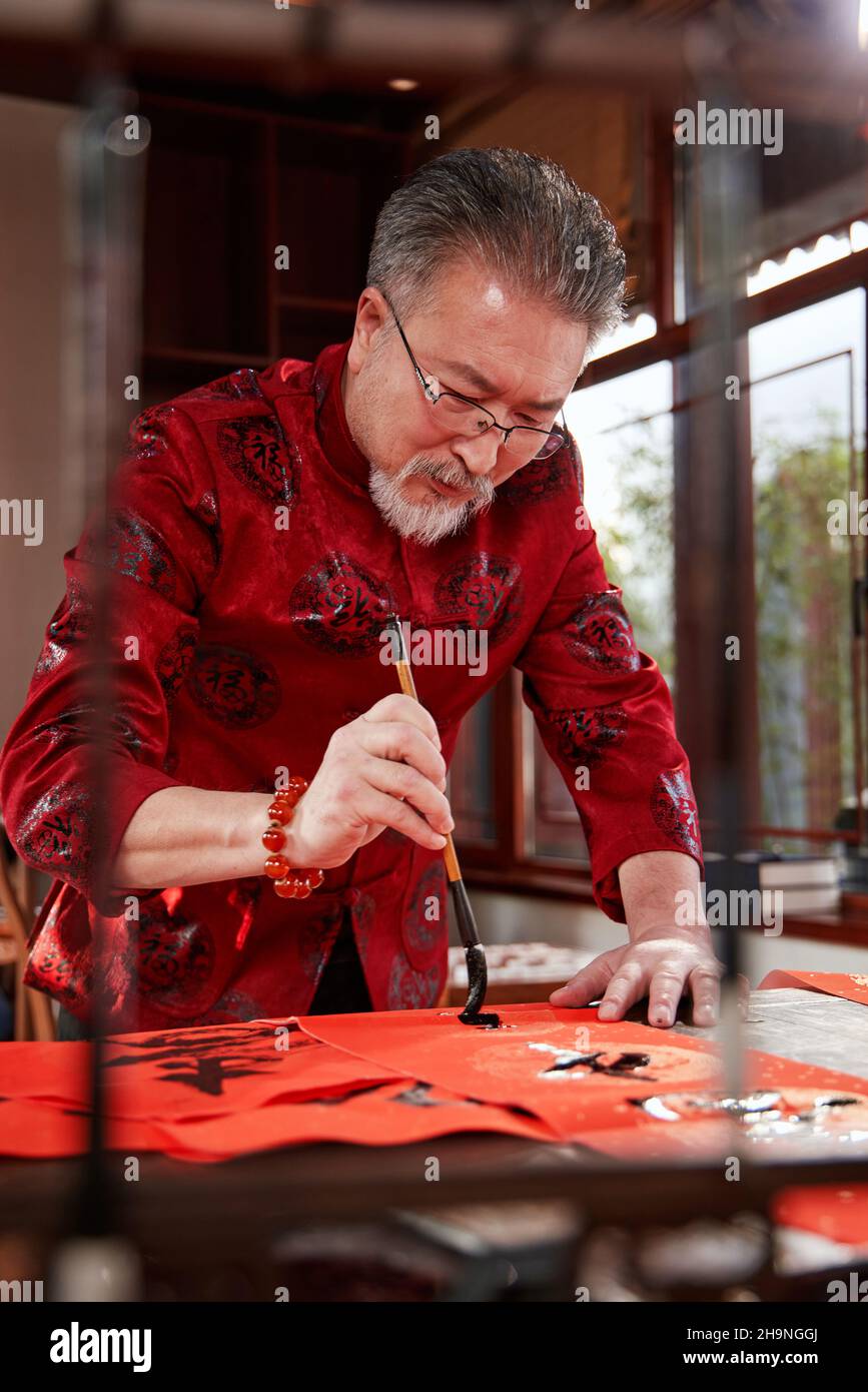 Older men write calligraphy Stock Photo - Alamy