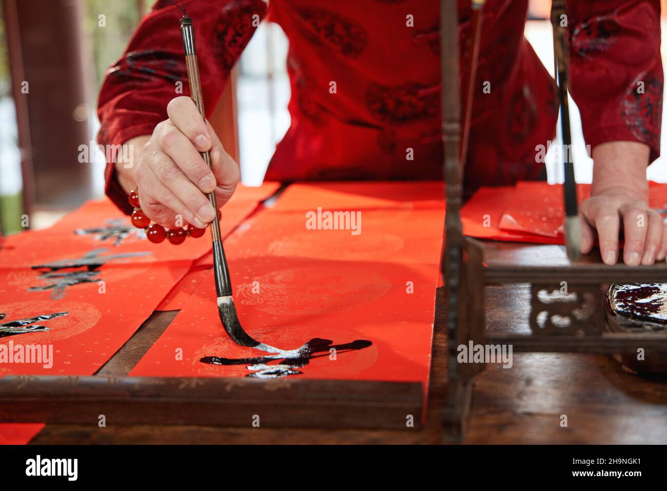 Older men write calligraphy Stock Photo - Alamy