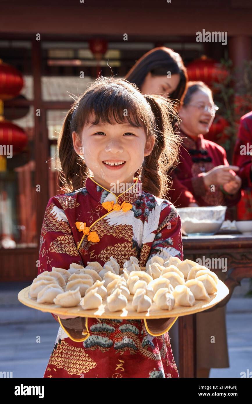 Cute girl with dumplings Stock Photo - Alamy