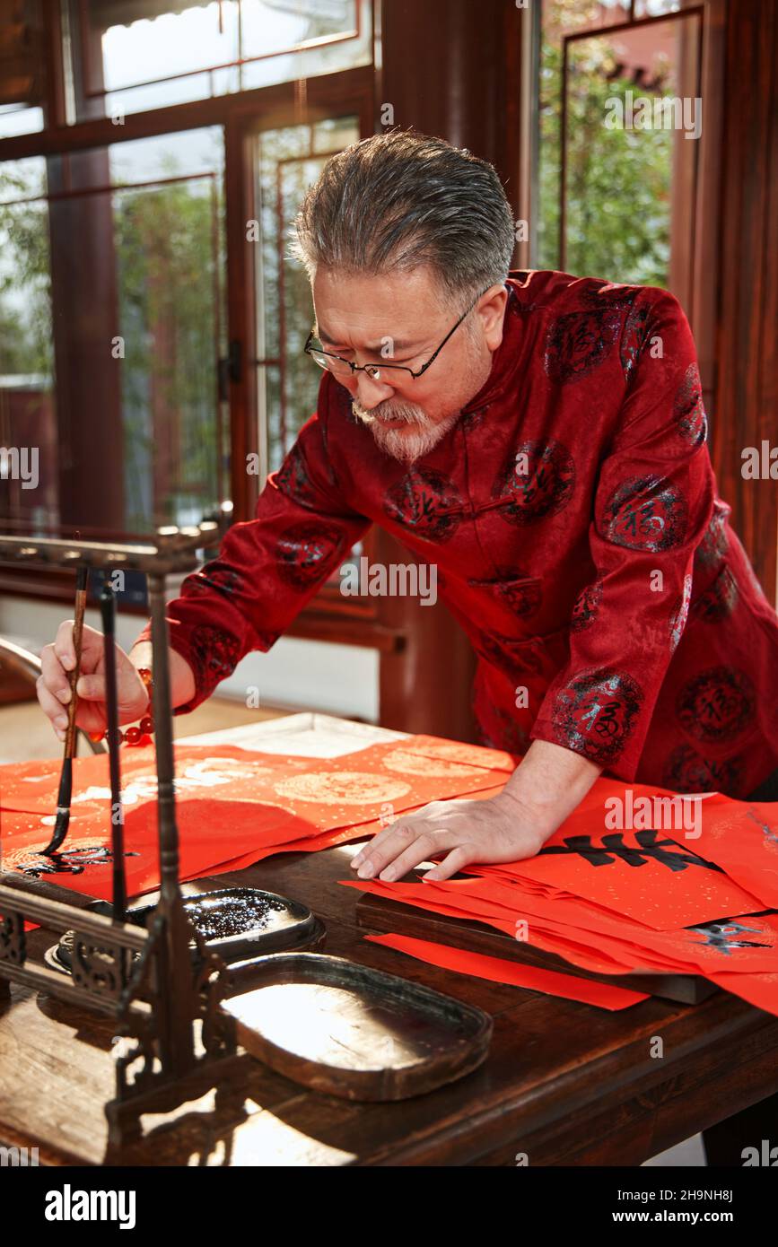 Older men write calligraphy Stock Photo - Alamy
