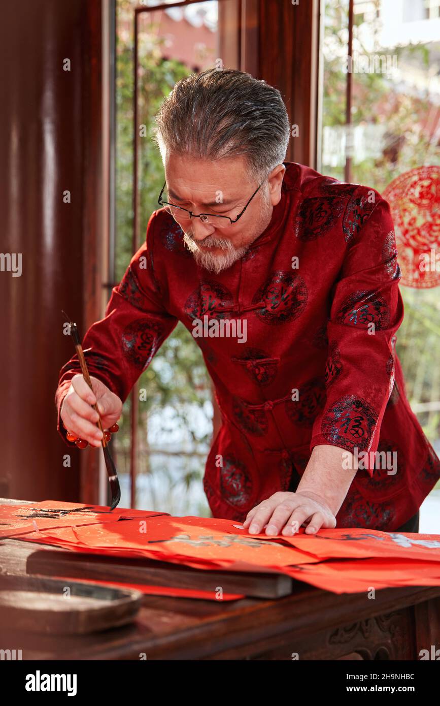 Older men write calligraphy Stock Photo - Alamy