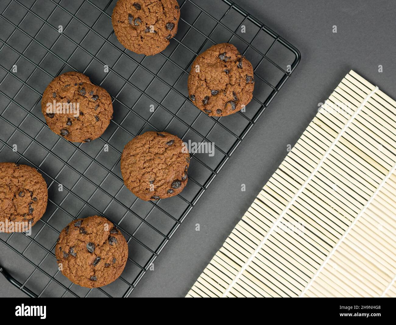 chocolate chip cookies on cooling rack on black background Stock Photo ...