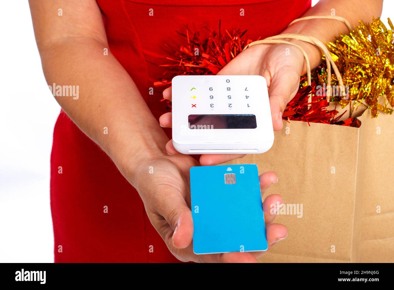 Female hand with credit card paying through terminal for retail ...