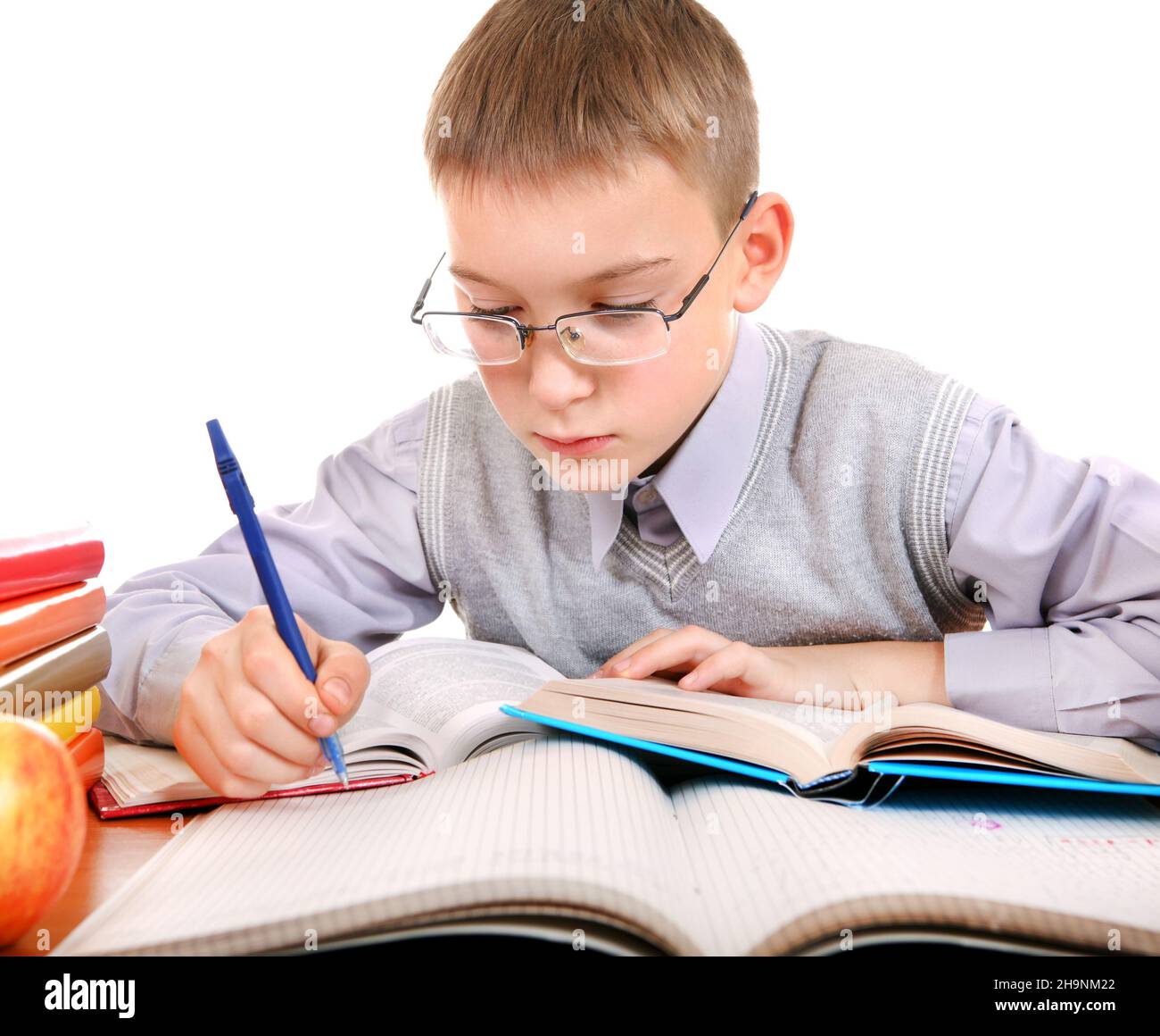 Kid write at the School Desk on the white background Stock Photo - Alamy