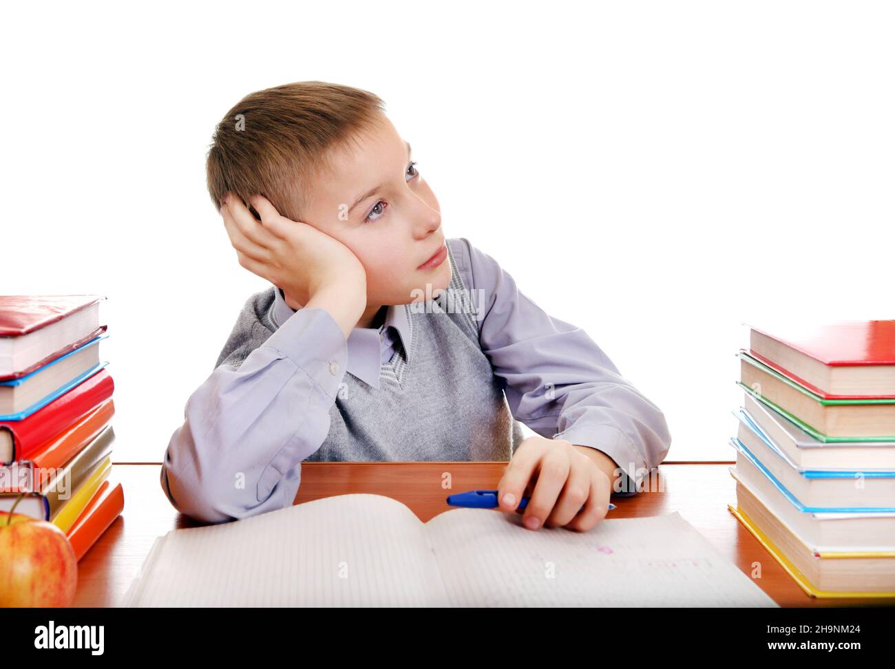 Bored Kid on the School Desk Isolated on the white background Stock ...