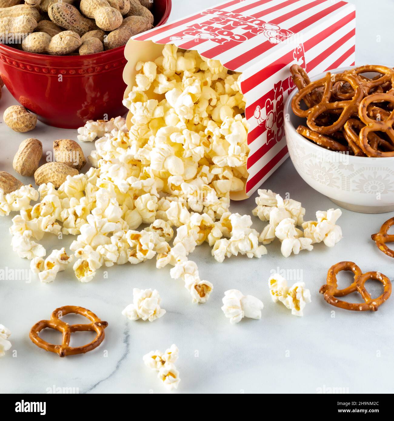 Close up of containers of peanuts, popcorn and pretzels ready for ...