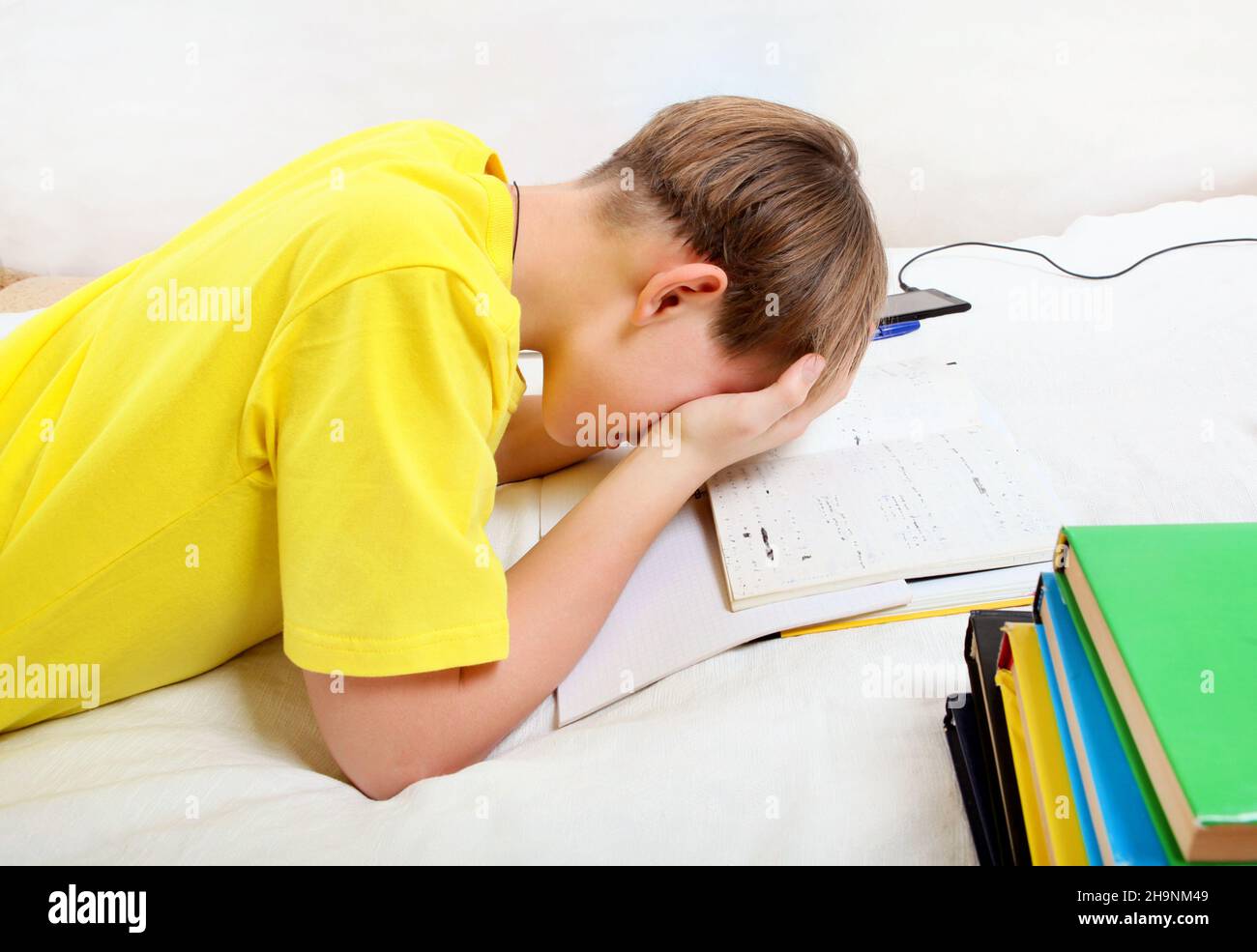 Teenager boy homework bed hi-res stock photography and images - Alamy