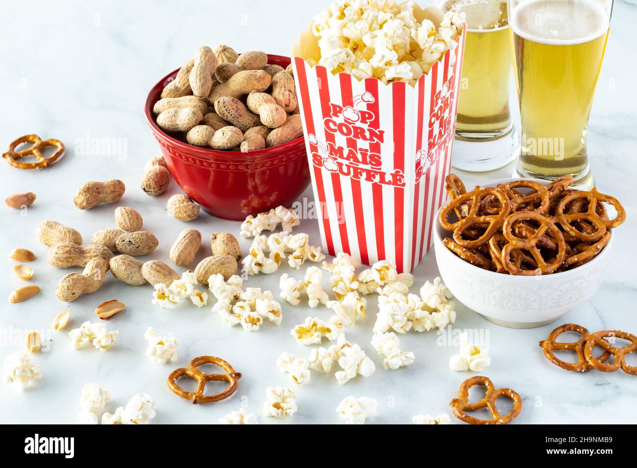 Peanuts, popcorn and pretzels served with beer, ready for snacking ...