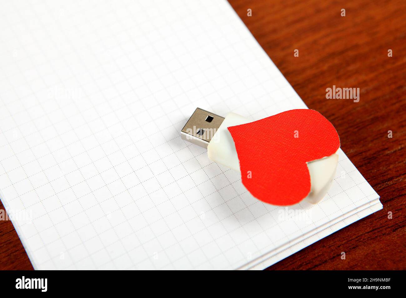 USB Flash Drives with Heart Shape on the Blank Note Pad Stock Photo - Alamy