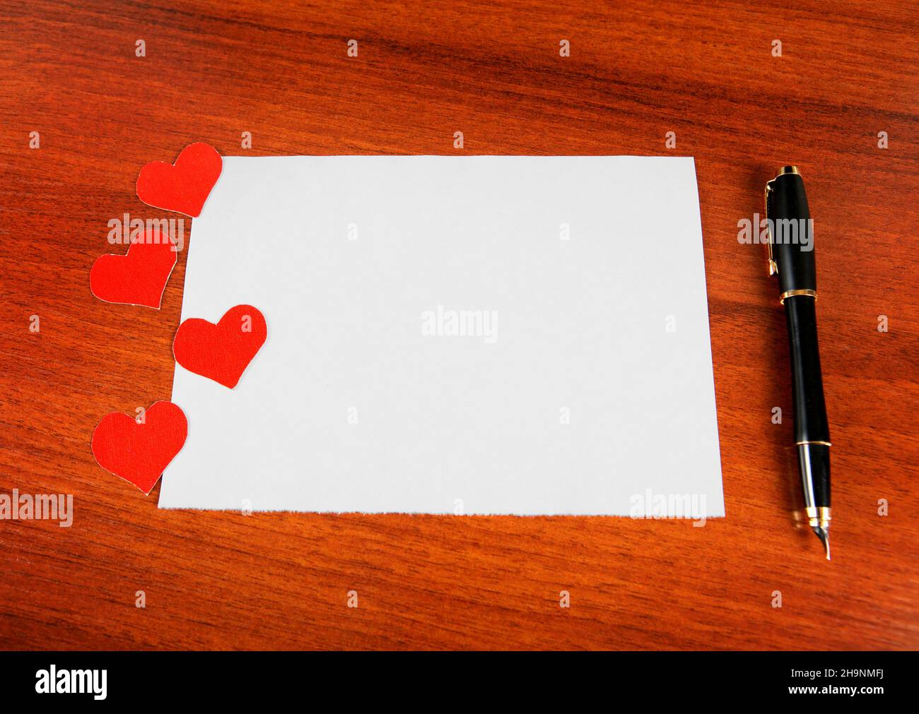 Blank Writing Pad with Heart Shapes and Pen on The Table Stock Photo ...