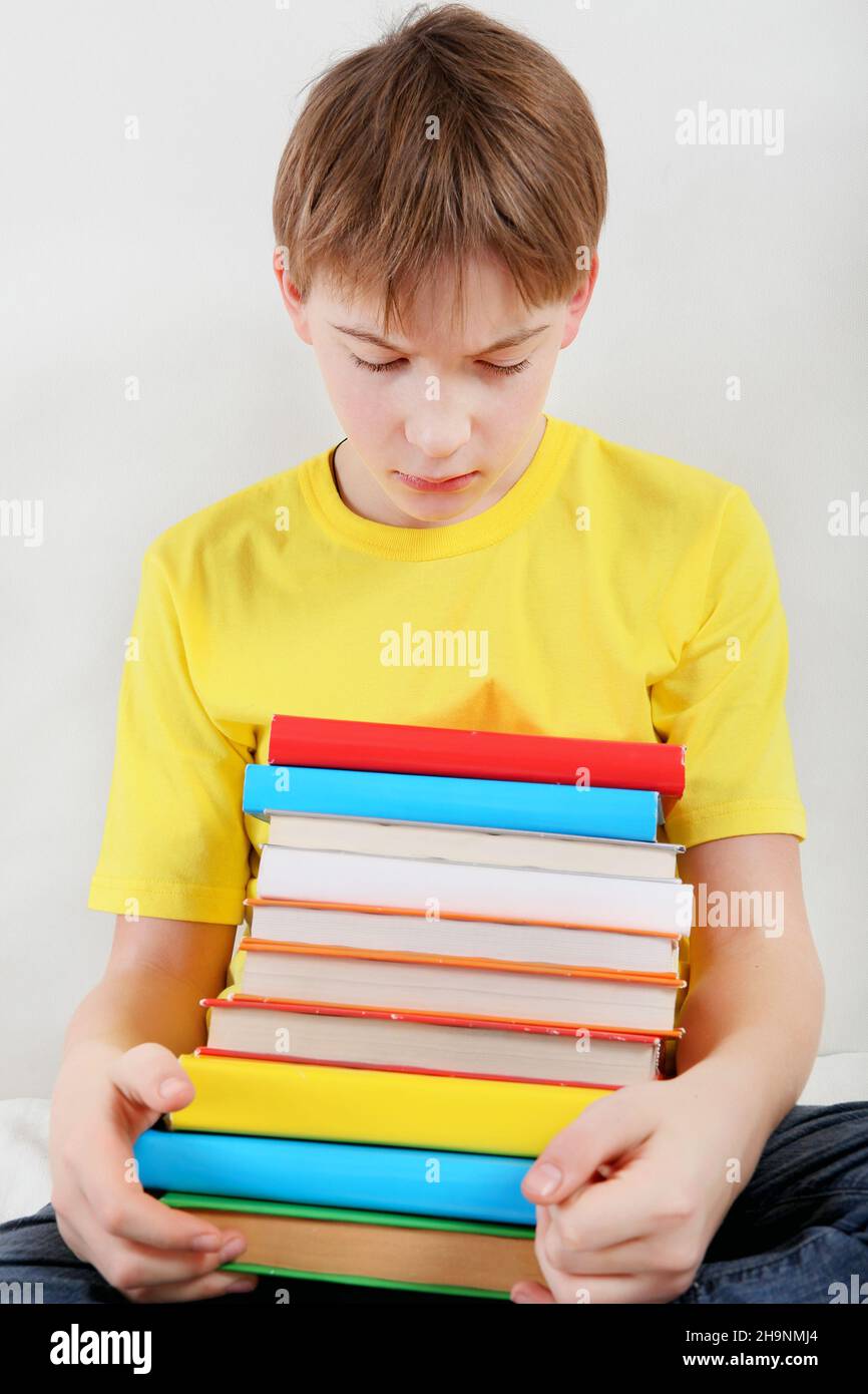 Sad Kid with a Books at the Home Stock Photo - Alamy