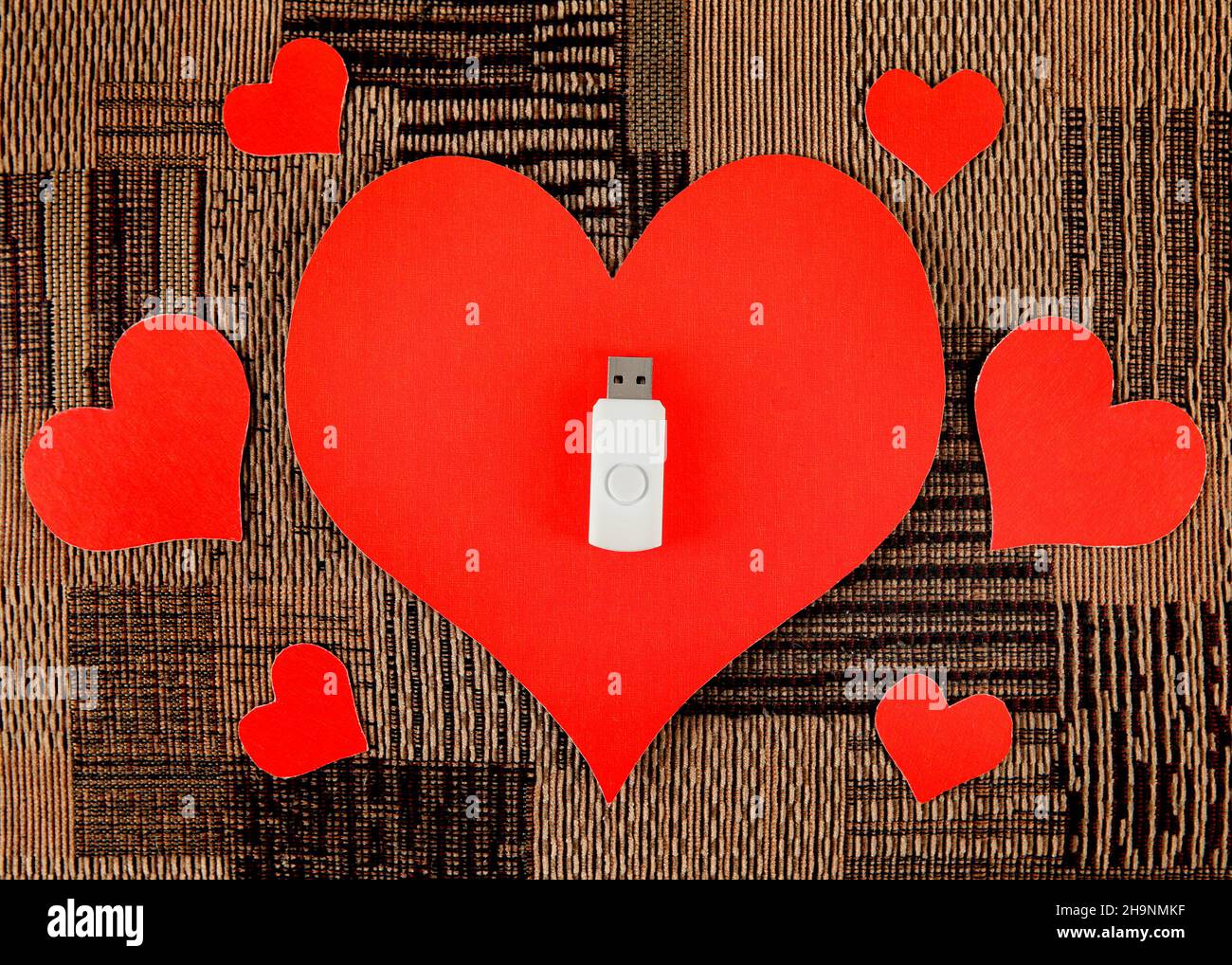 USB Flash Drive with Heart Shape on the Fabric Background Stock Photo ...