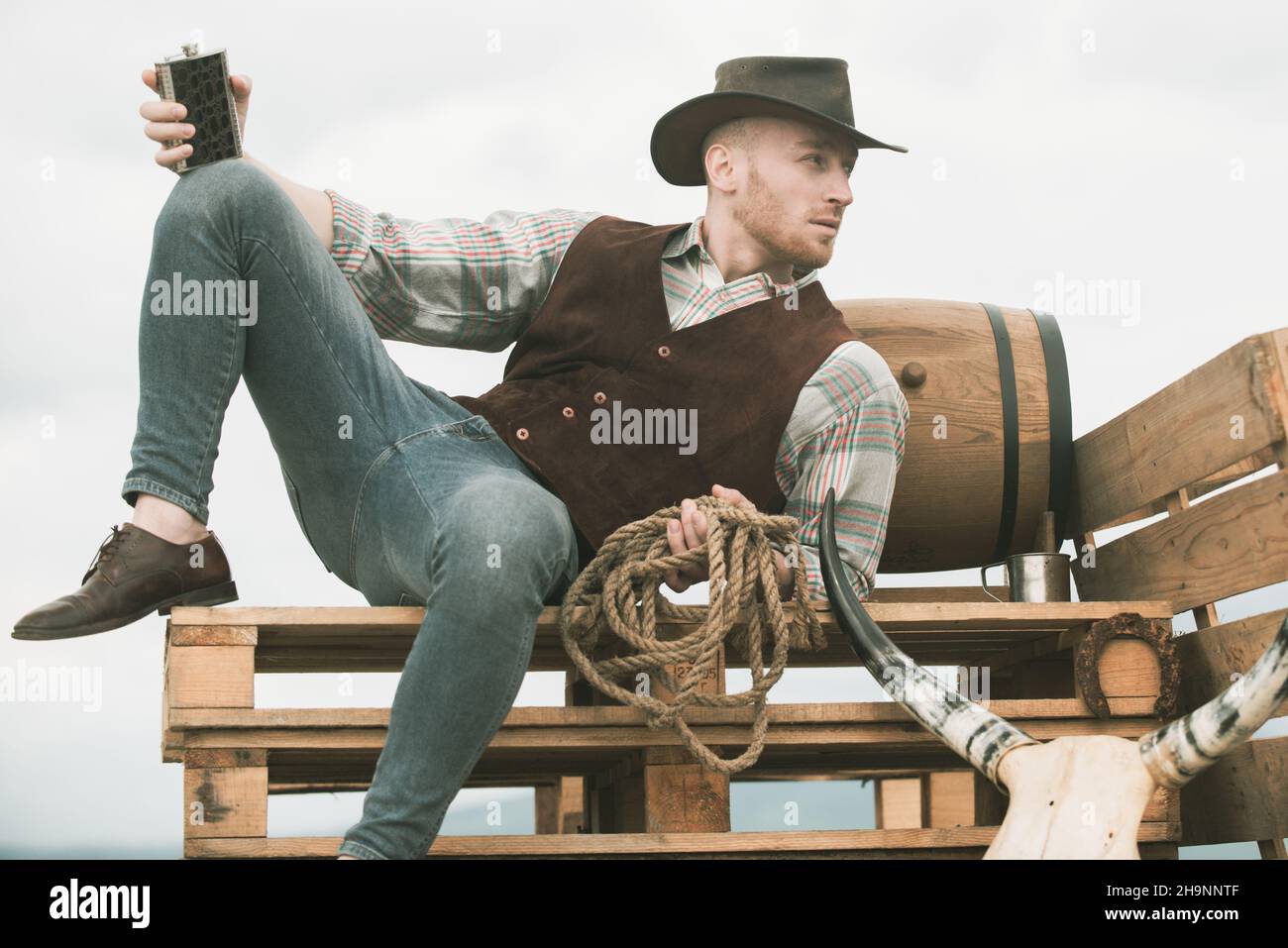 Cowboy on ranch. Handsome man in cowboy hat and retro vintage outfit ...