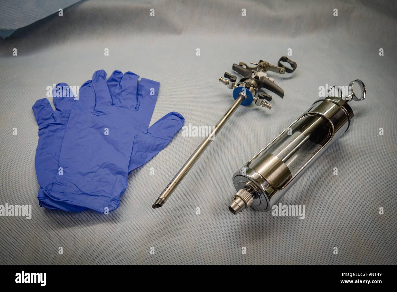 instrument for performing a prostate resection lies next to blue ...