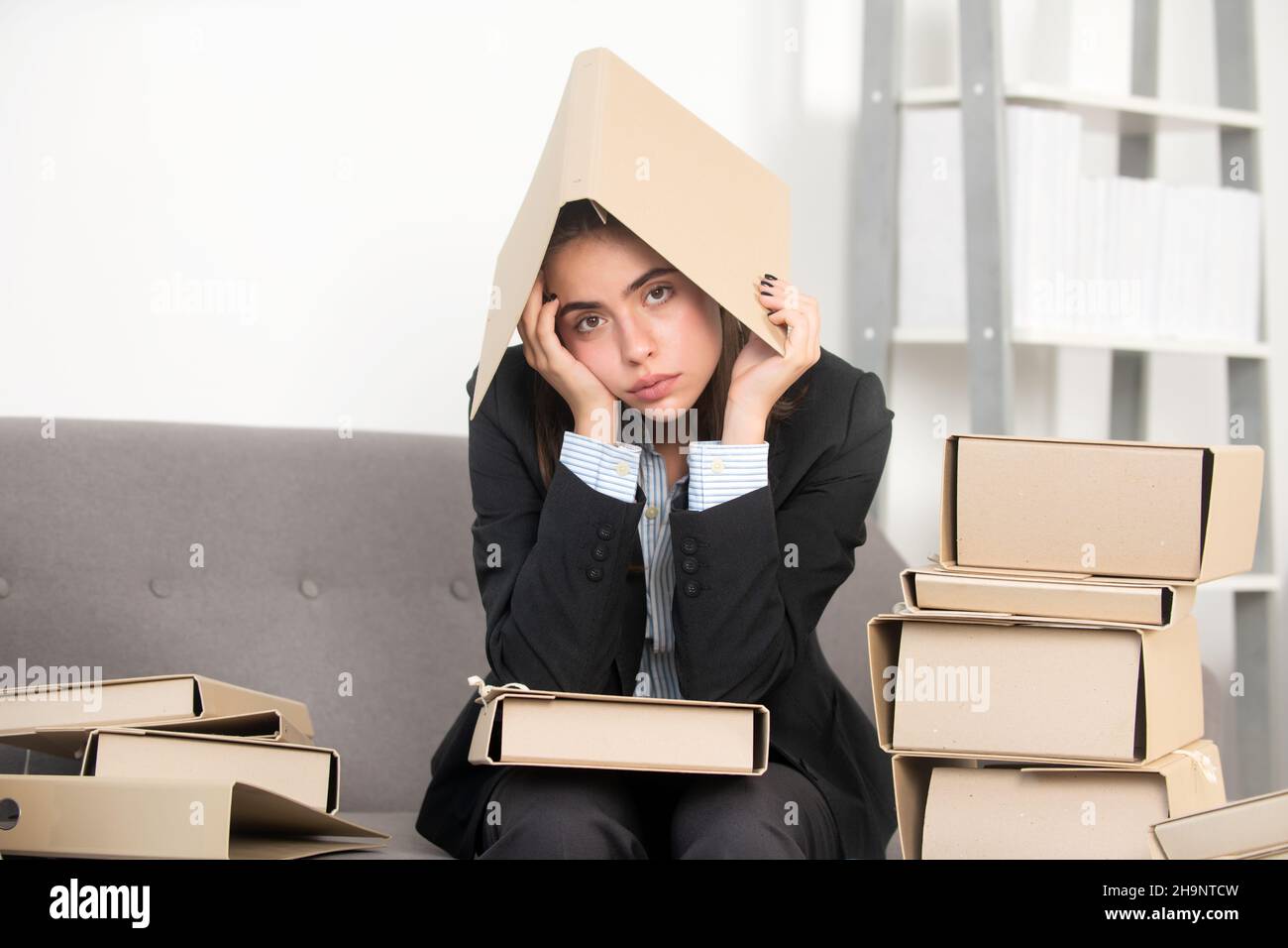 Sad busy secretary with folder on head, stressed overworked business ...
