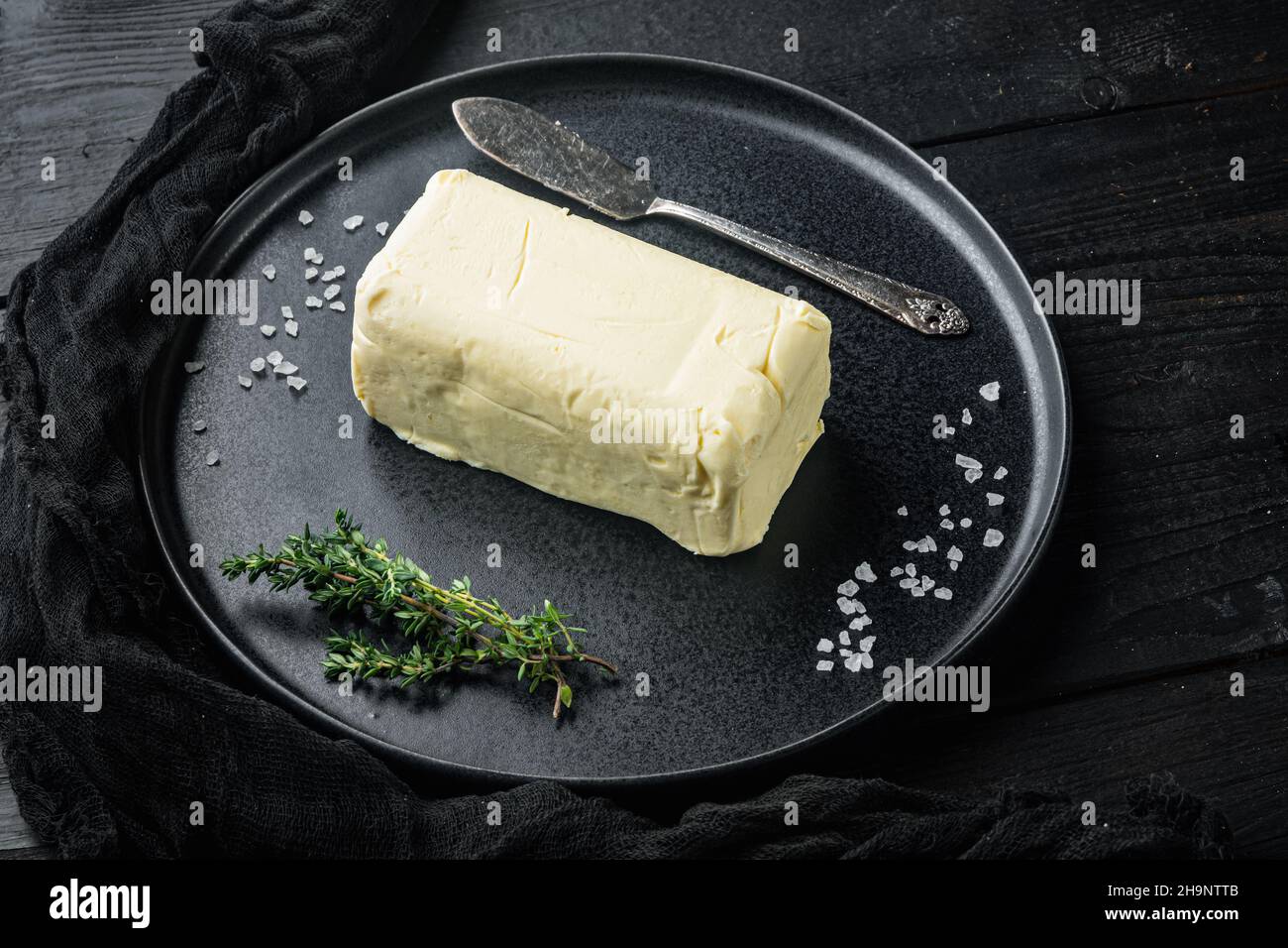 Dairy fresh butter, on black wooden table background Stock Photo - Alamy